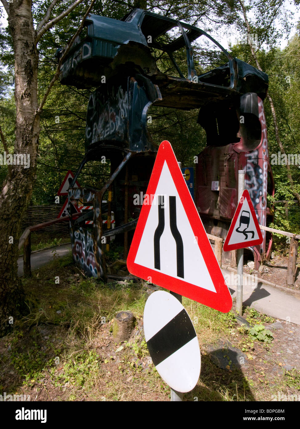 Road signs and a dead car sculpture at the centre for alternative ...
