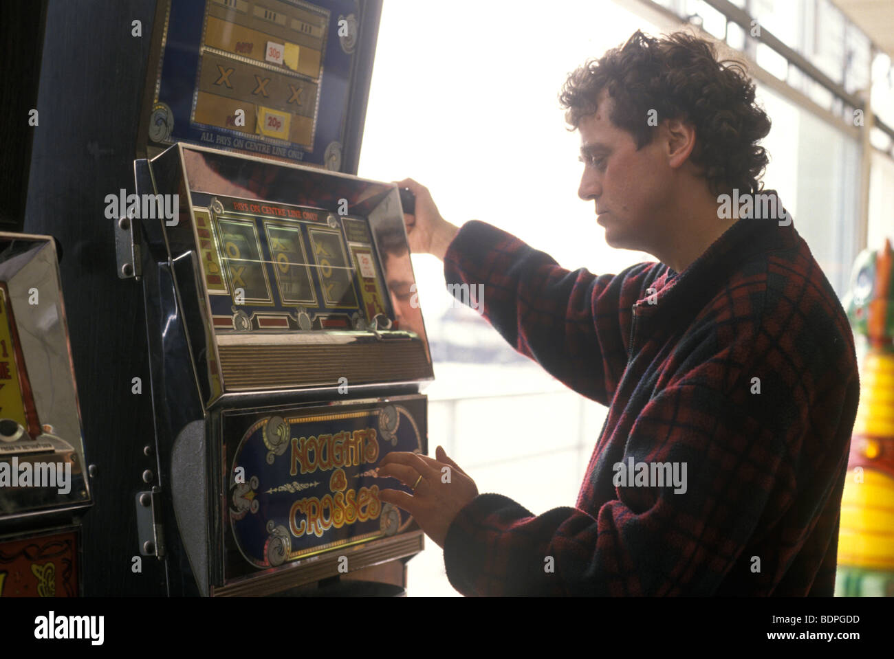 Playing the fruit machines hi-res stock photography and images - Alamy