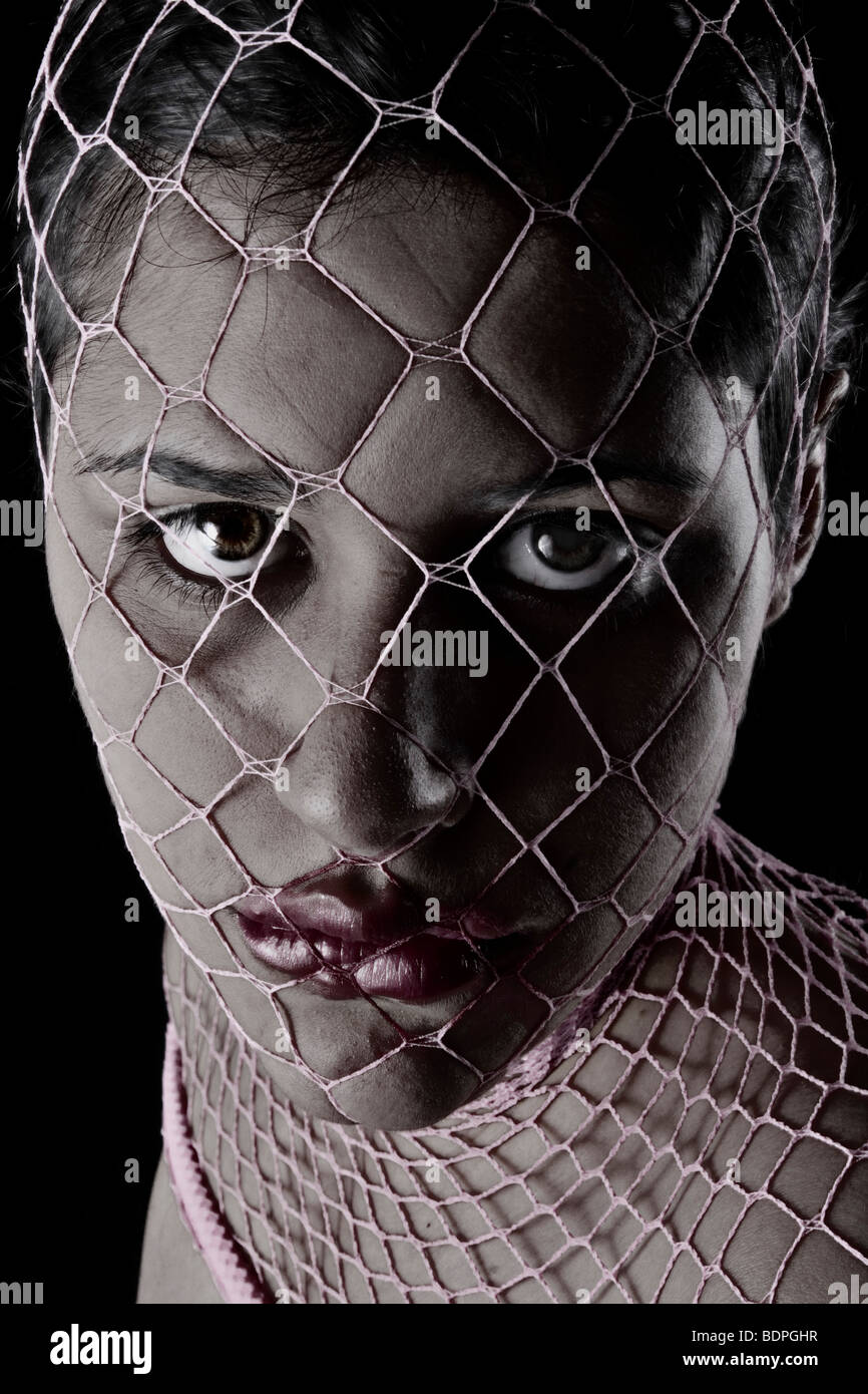 The face of a young woman in a net Stock Photo - Alamy