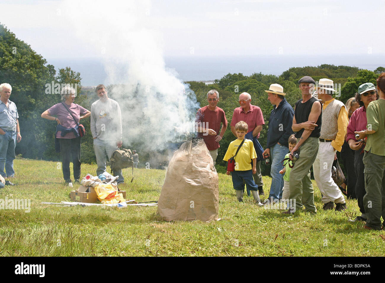 People gathered around a fire Stock Photo - Alamy