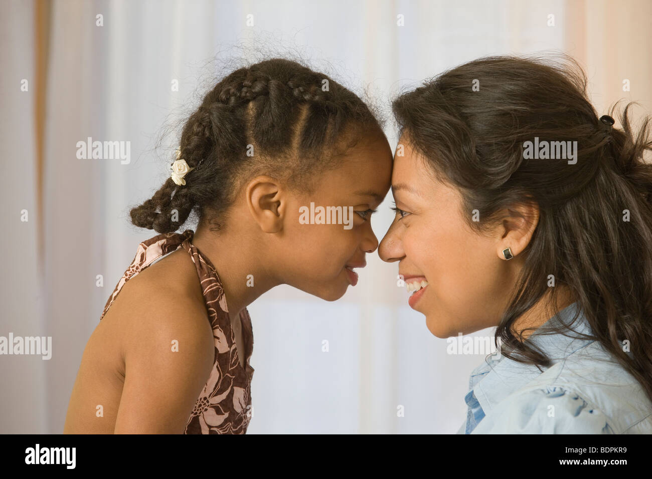 Hispanic woman rubbing noses with her daughter Stock Photo - Alamy