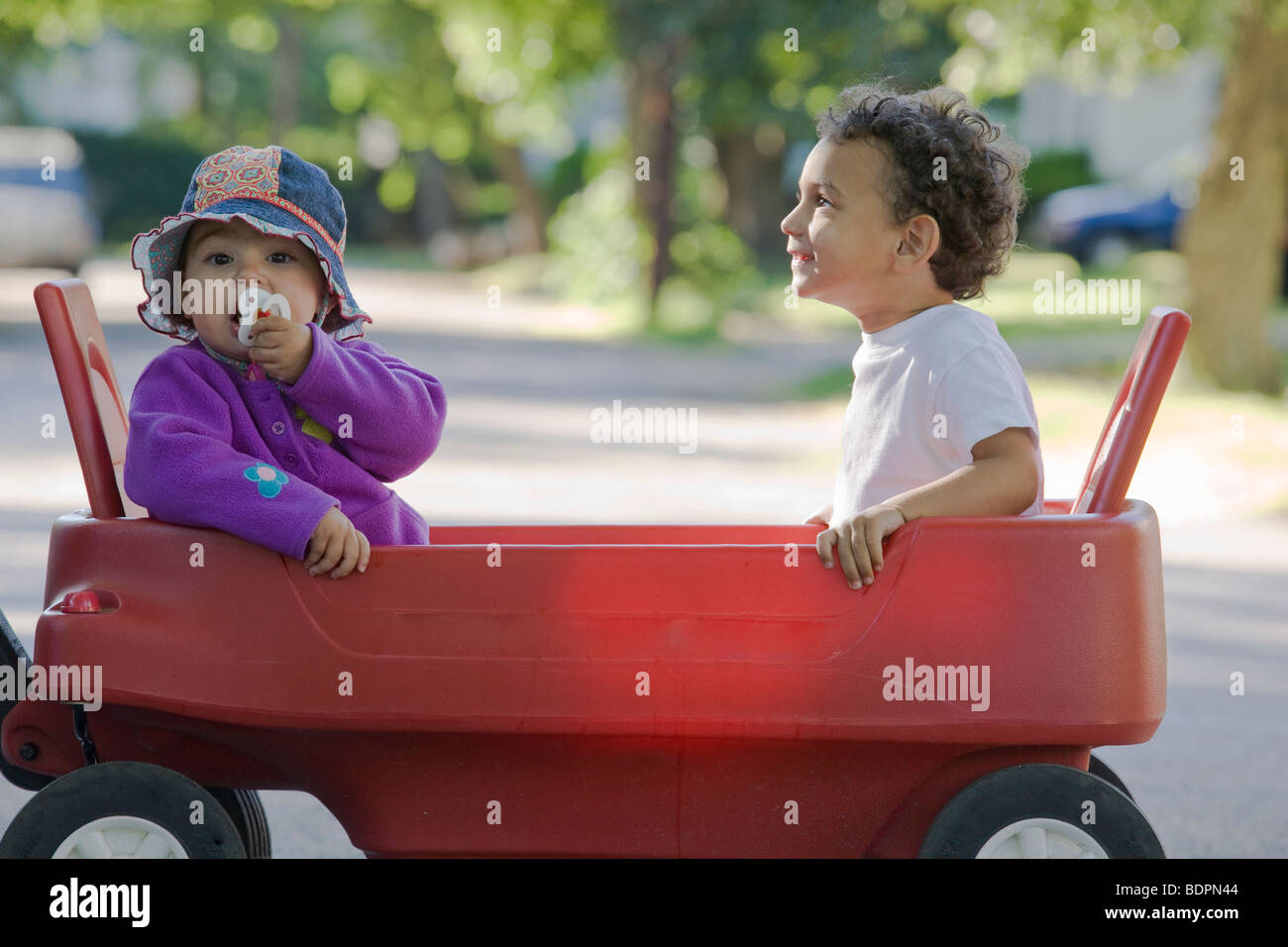 Two Hispanic children in a wagon Stock Photo - Alamy