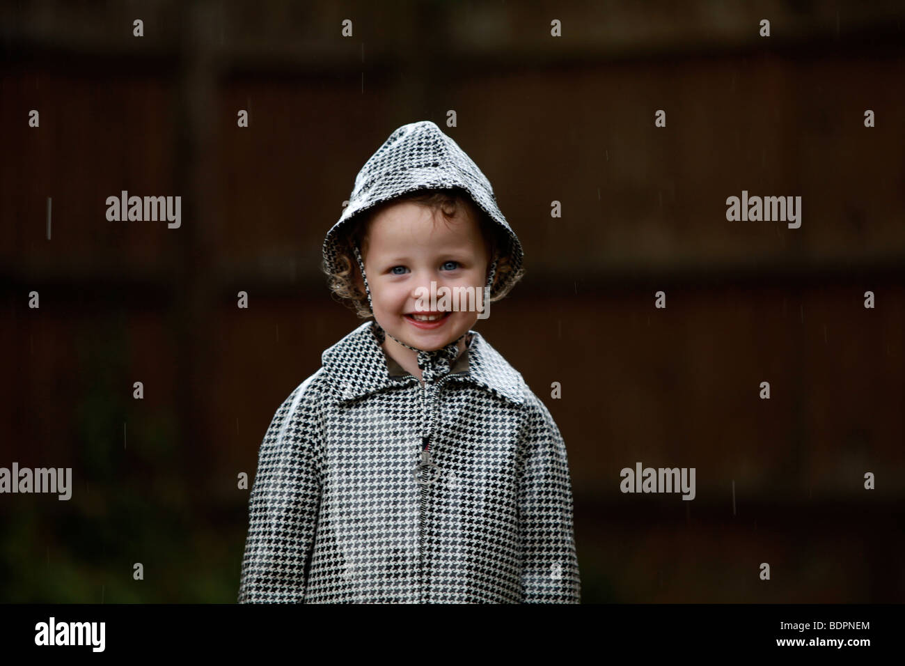 Girl standing in the rain Stock Photo - Alamy