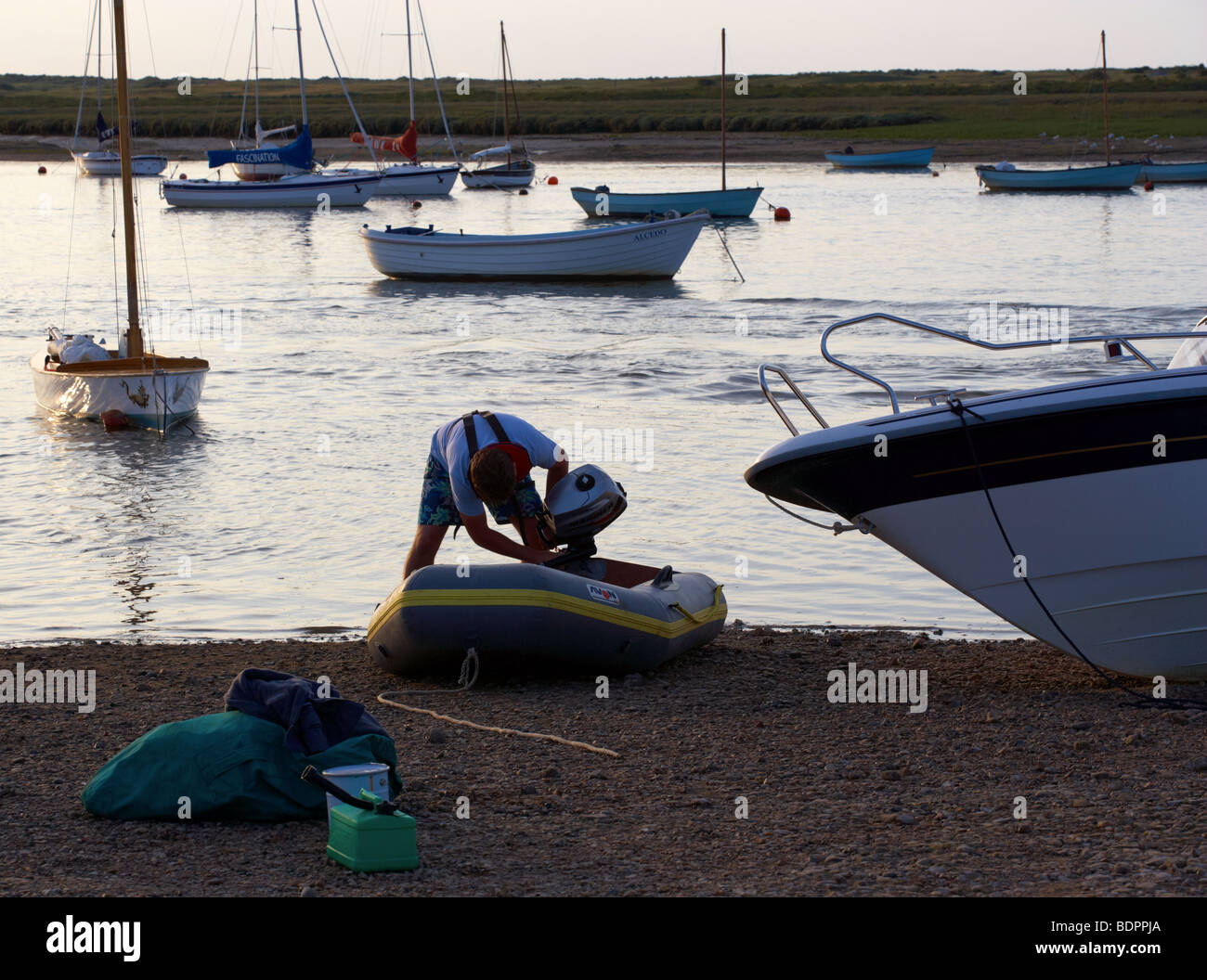 A man getting his boat ready for an evening sail from Brancaster ...