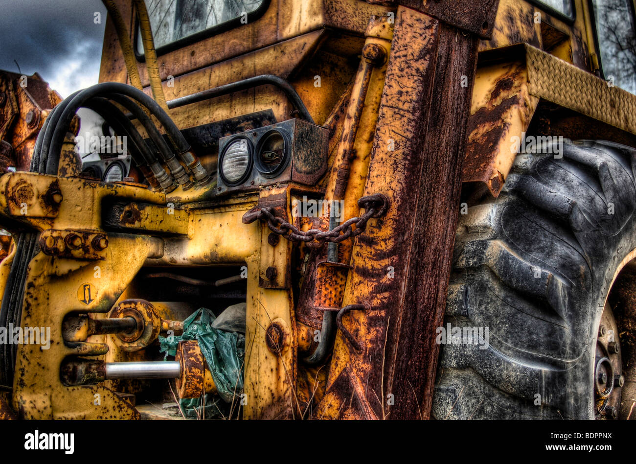 Rear view of a rusty old yellow digger Stock Photo - Alamy