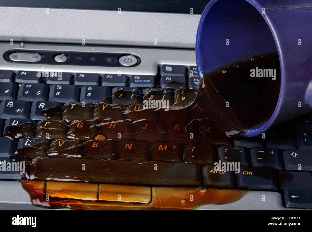 coffee spilling on keyboard Stock Photo - Alamy