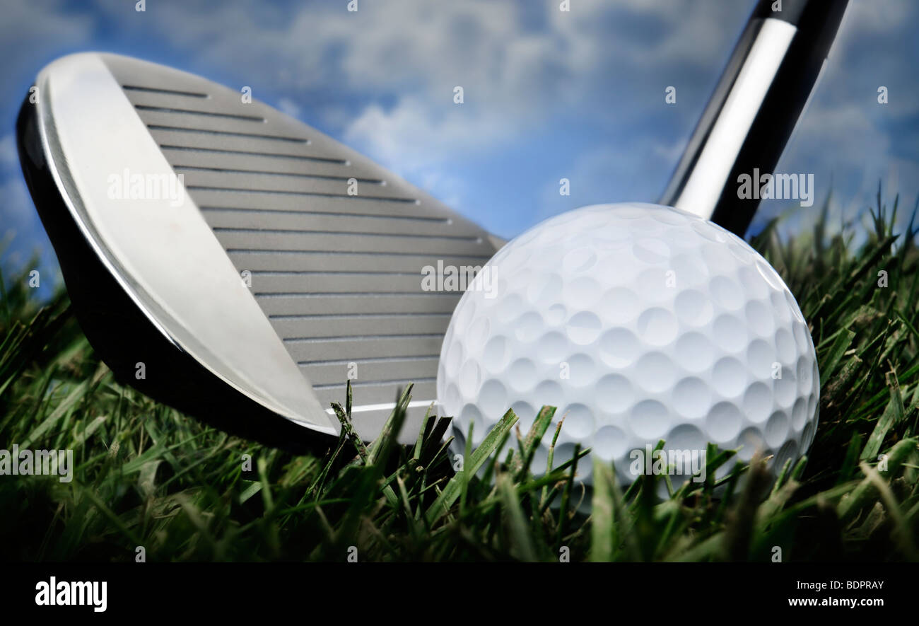 Golf club and ball in grass Stock Photo - Alamy