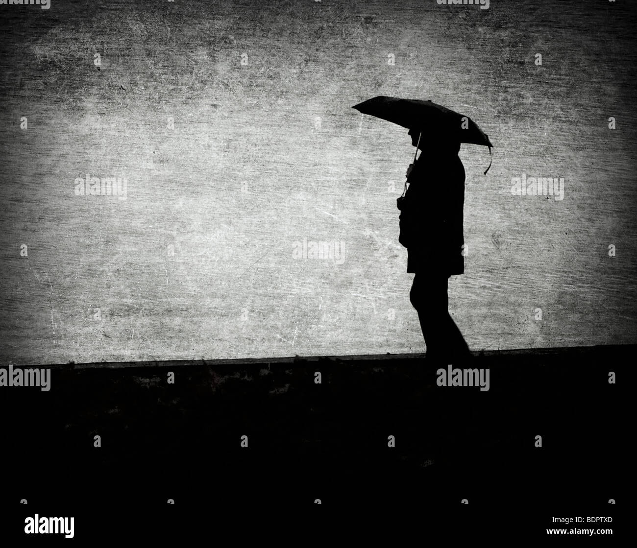 A person carrying an umbrella Stock Photo - Alamy