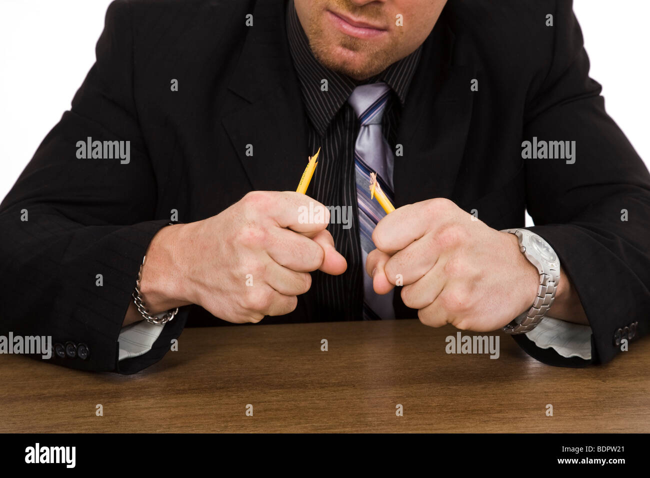 Caucasian businessman setting at a desk and looking very angry and ...