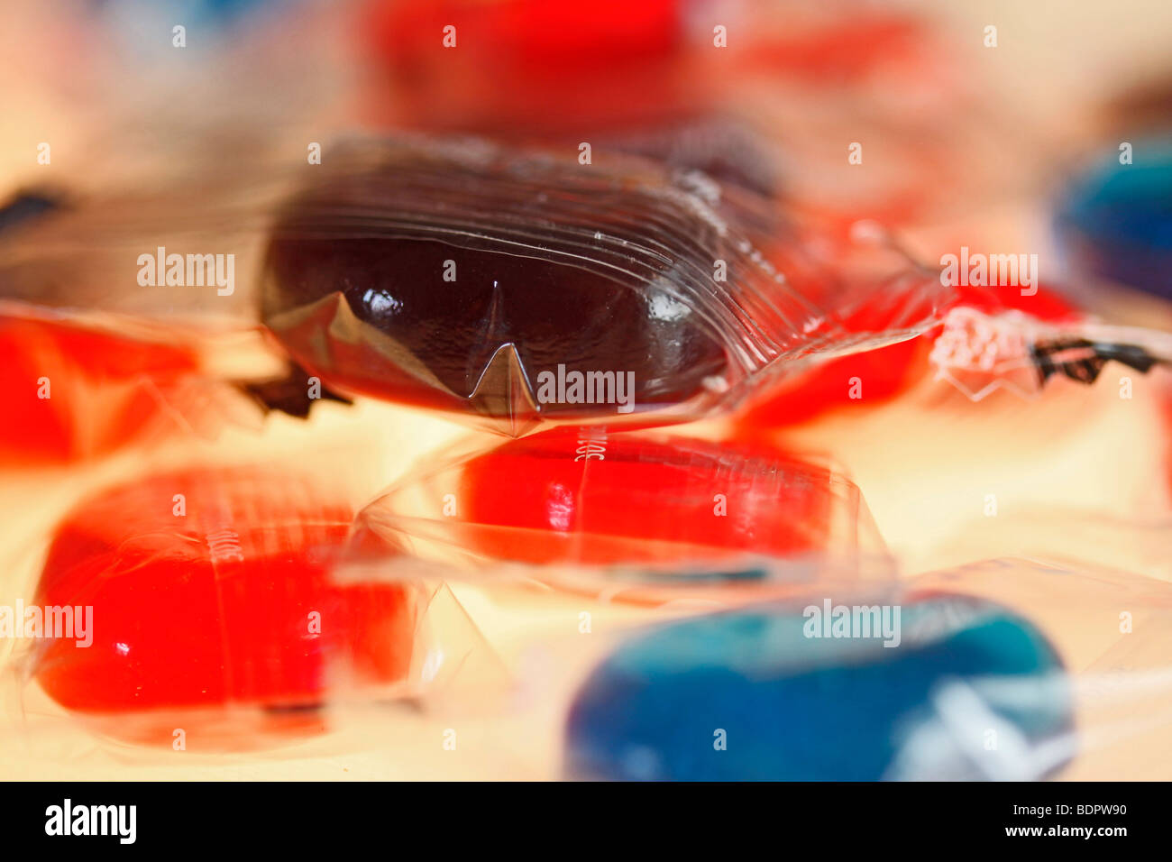 Brightly coloured sweets weapped in plastic Stock Photo - Alamy