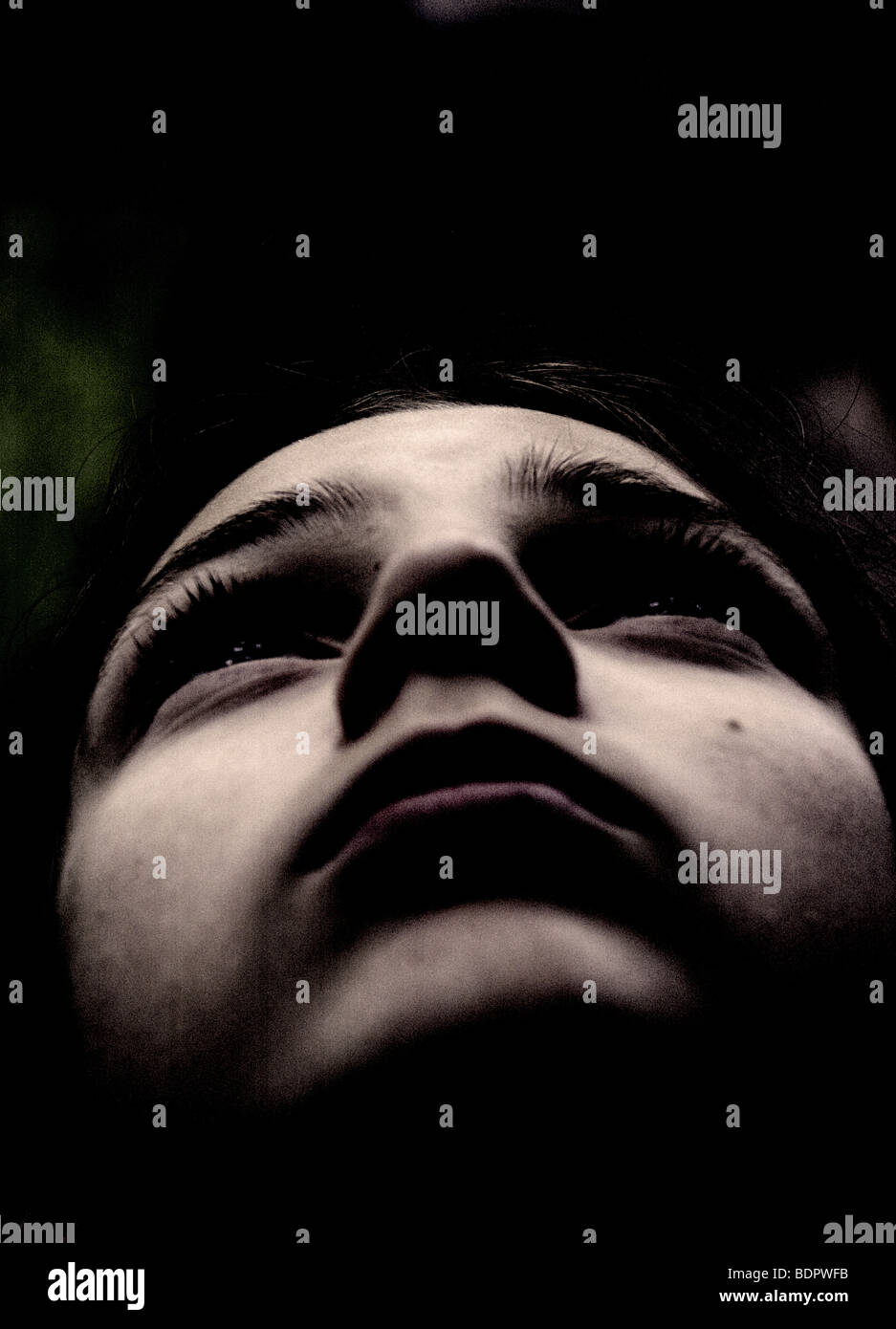 The face of a young girl gazing upwards Stock Photo - Alamy