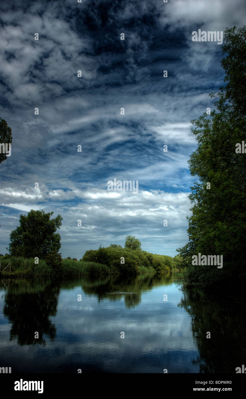 Blue sky over a river Stock Photo - Alamy