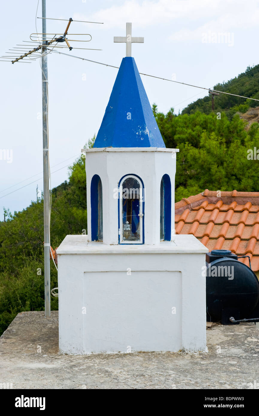 Roadside shrine next to village house at Markopoulo on Greek island of ...
