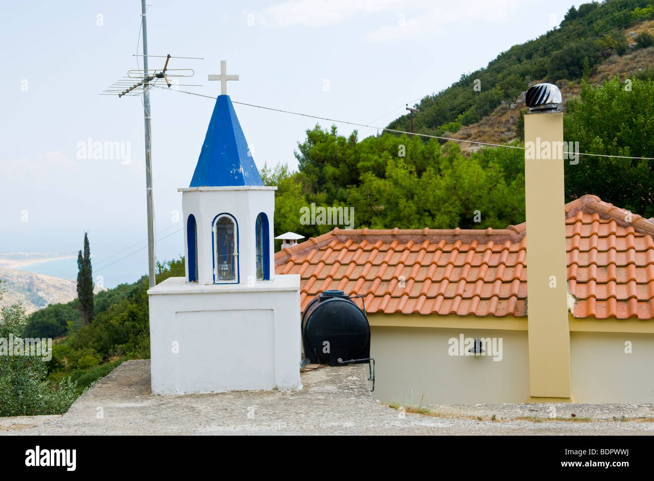 Roadside shrine next to village house at Markopoulo on Greek island of ...