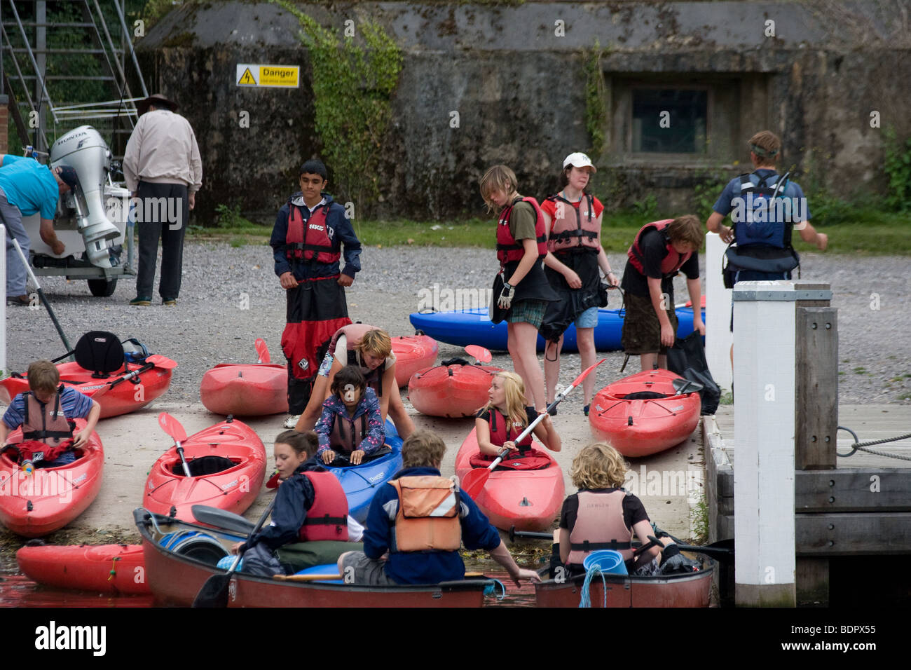 young canoes canoeists launching boat slipway river Medway allington ...