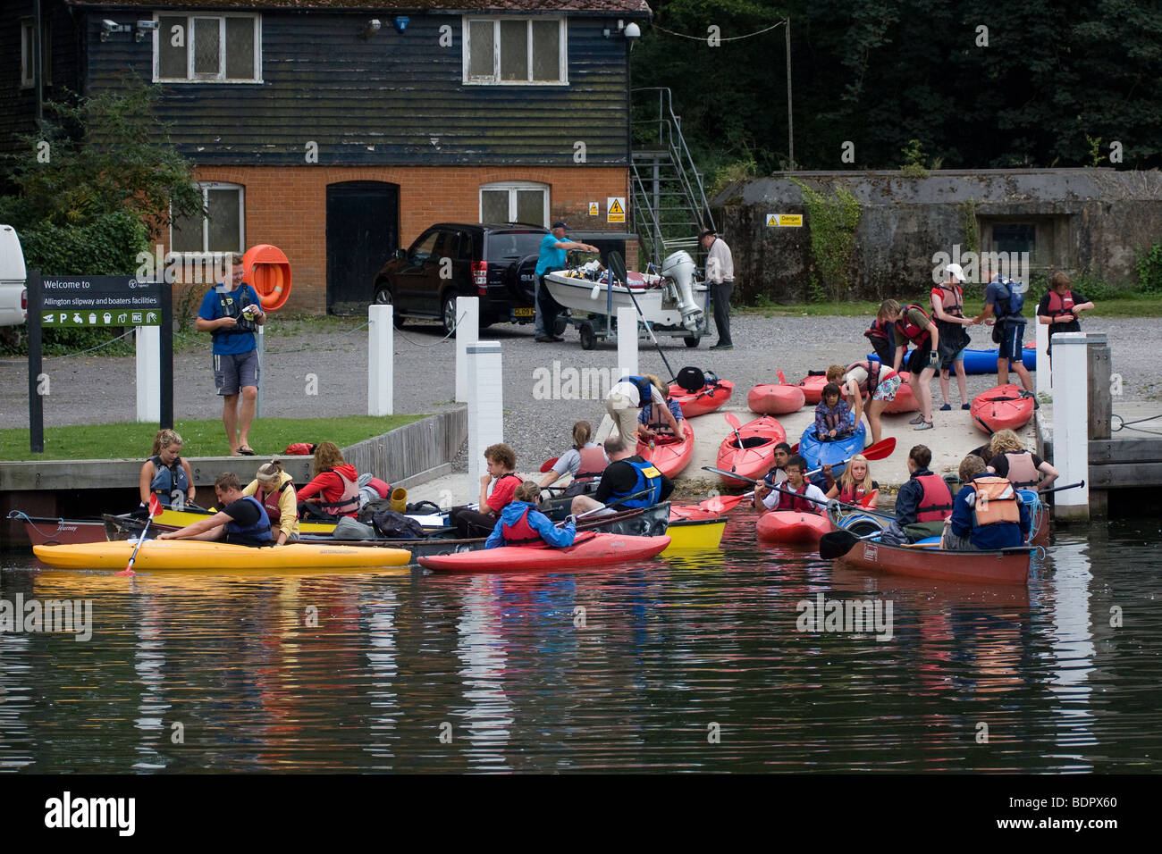 young canoes canoeists launching boat slipway river Medway allington ...