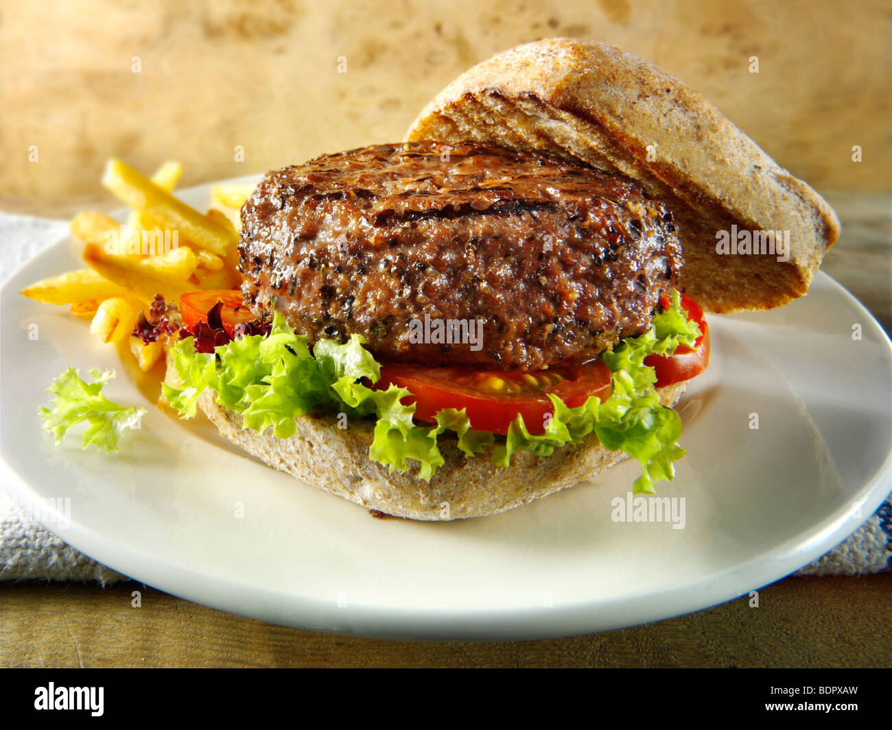 Peppered beef burger with chips and wholemeal bun Stock Photo - Alamy