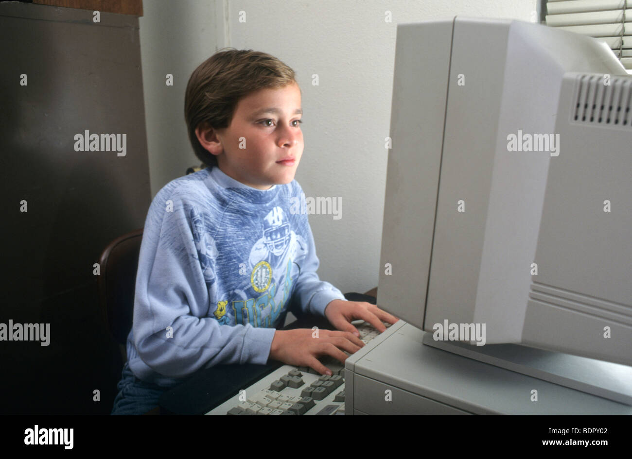 male kid keyboard pc monitor study search research type read screen ...