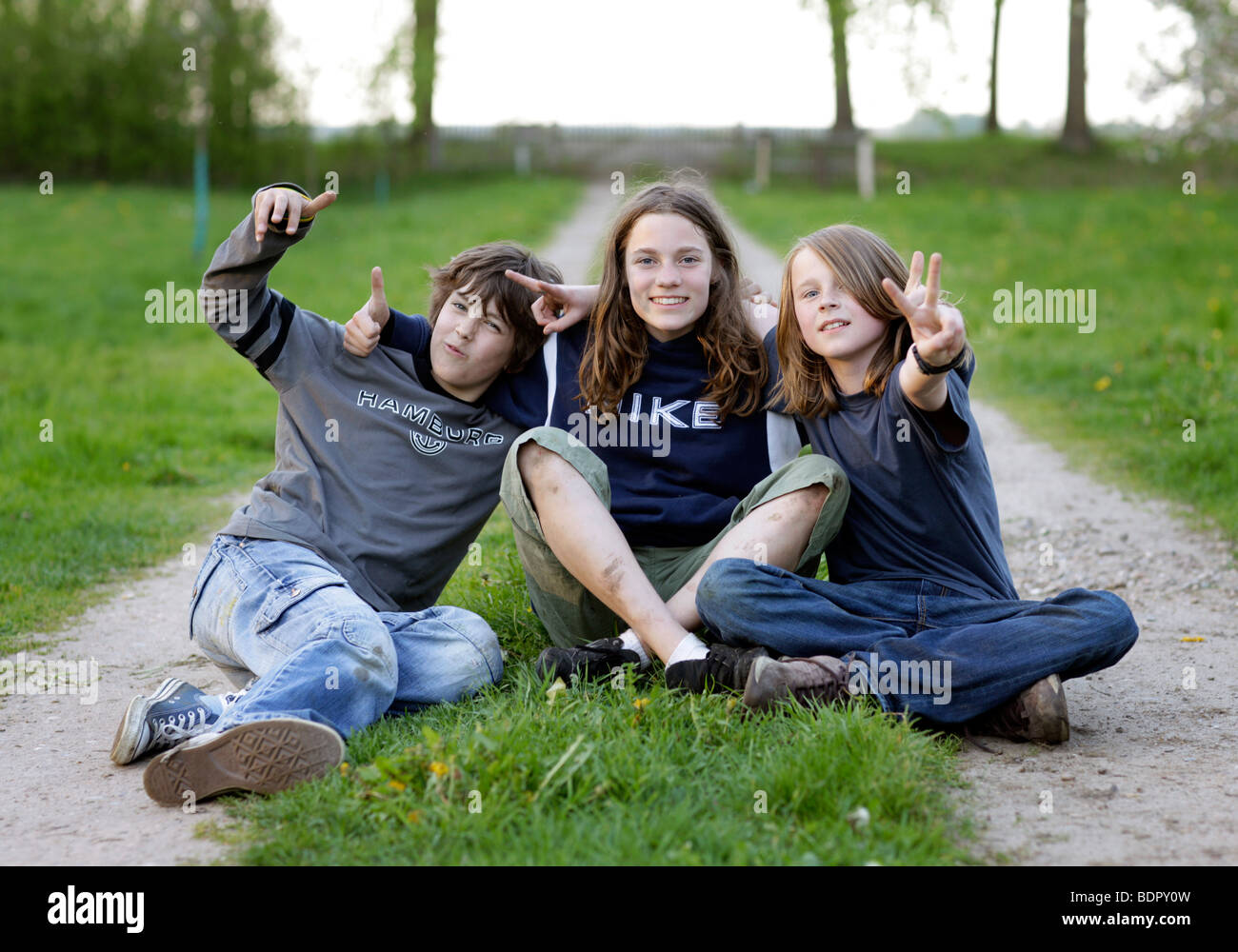 Boys giving victory signs Stock Photo - Alamy