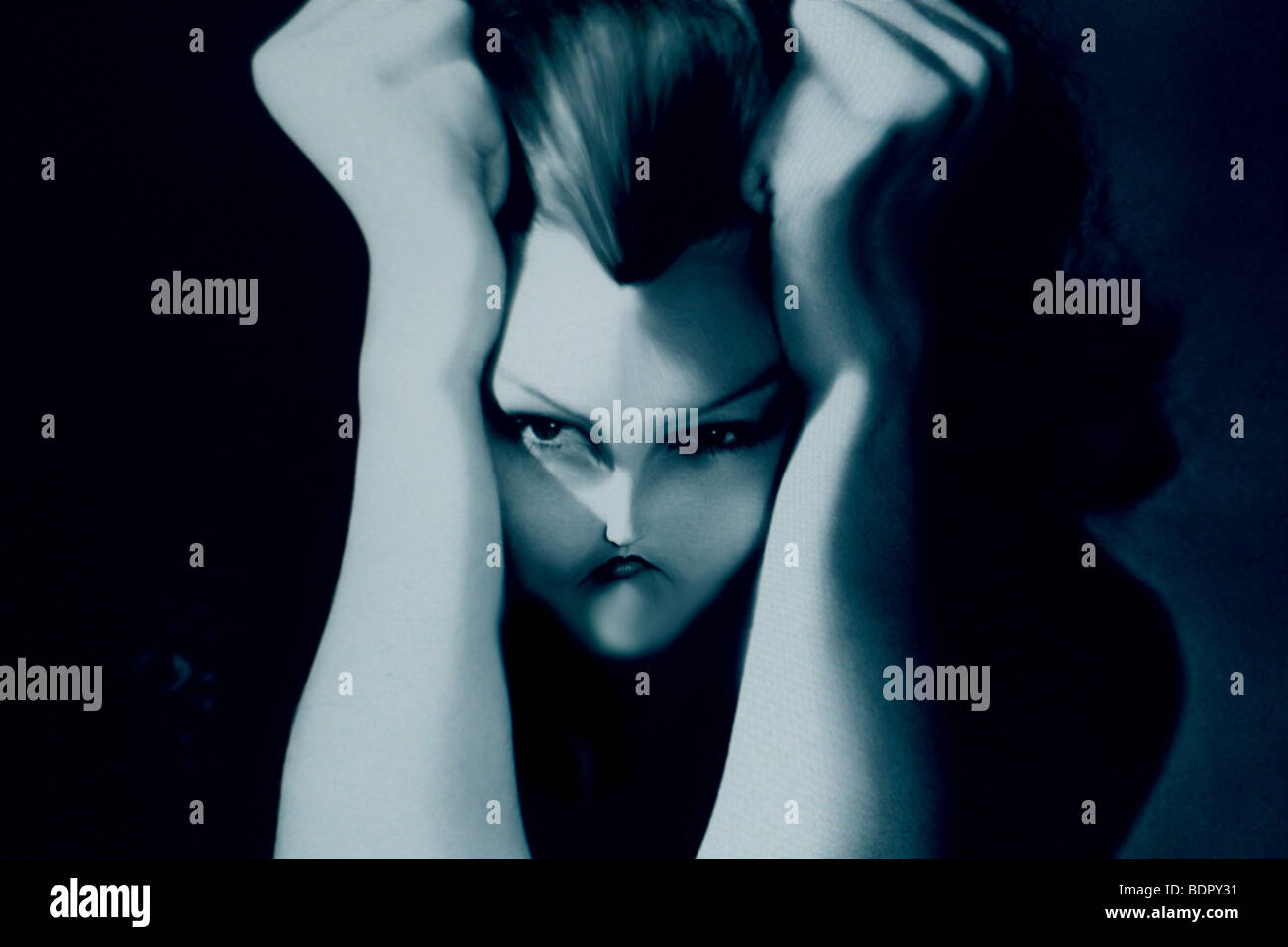 A distorted womans face holding her head in her hands Stock Photo - Alamy