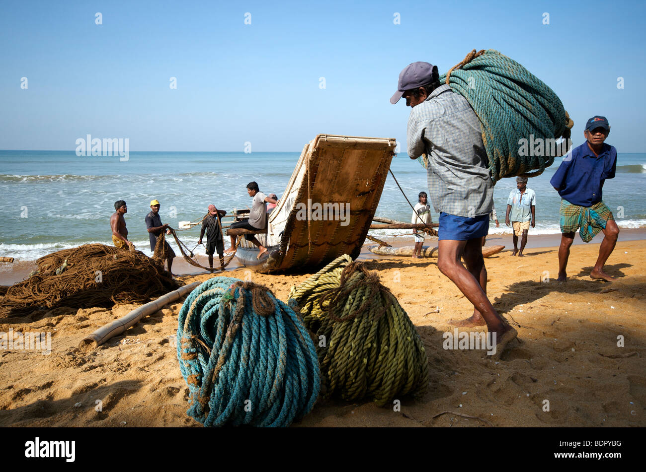 Fishermen carrying boat beach hi-res stock photography and images - Alamy