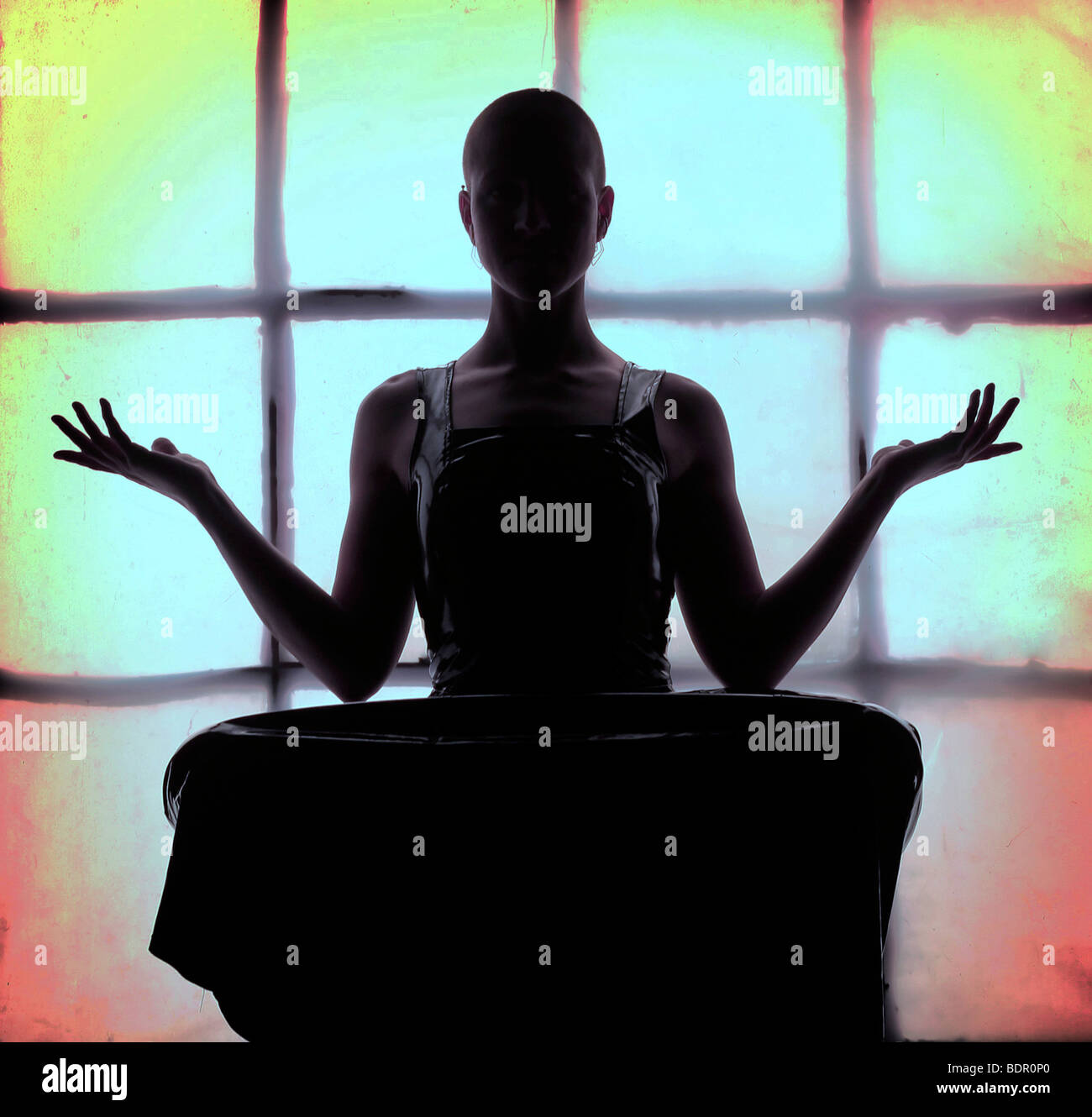 The silhouette of a young woman sitting cross legged Stock Photo - Alamy