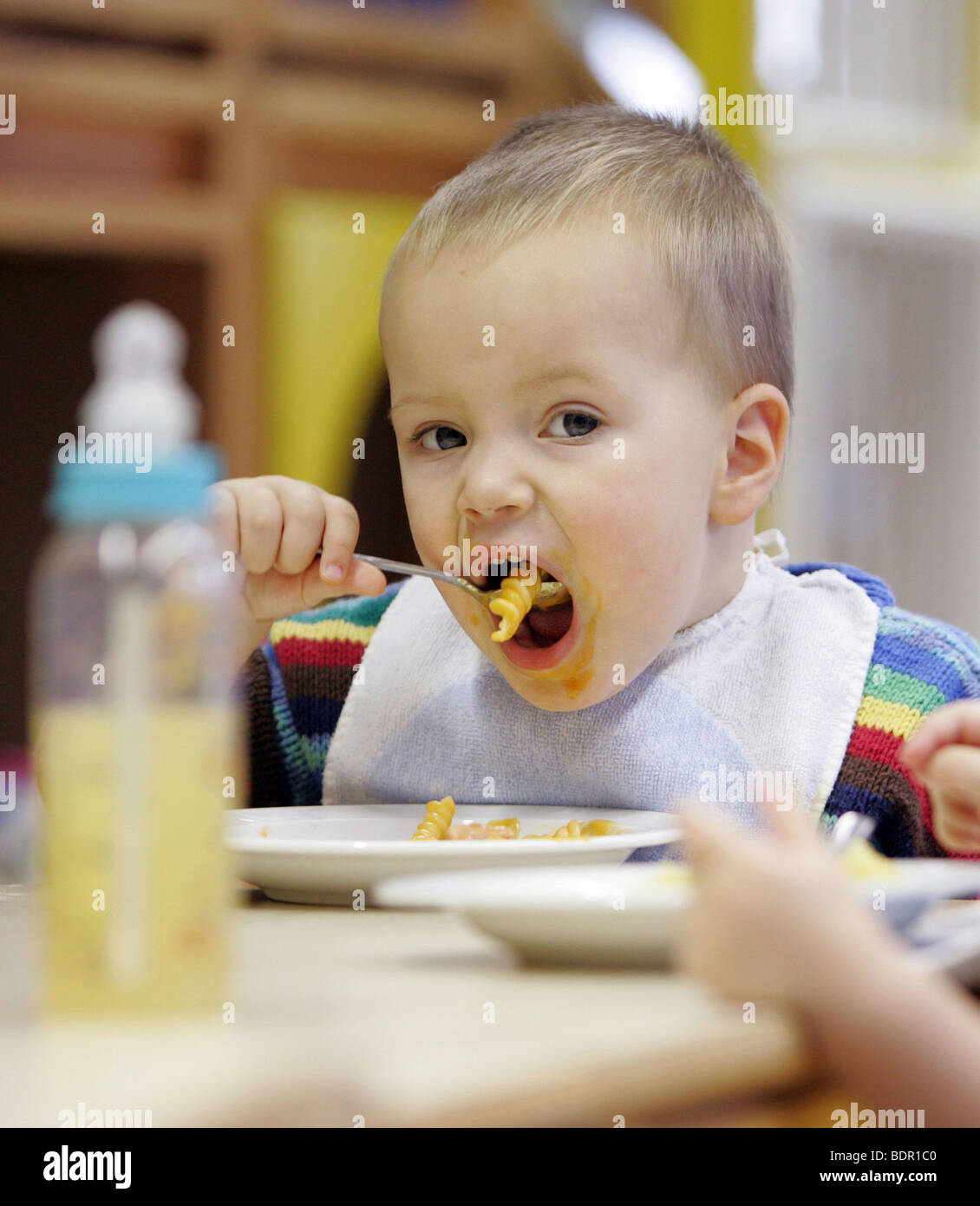 Child eating at Kindergarten class Stock Photo - Alamy