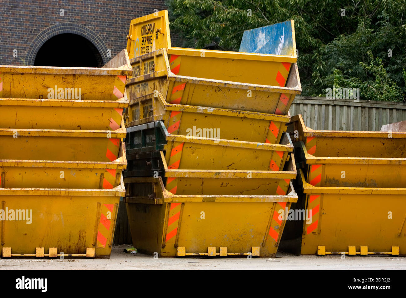 A stack of empty yellow skips ready to be hired out in Brighton, East ...