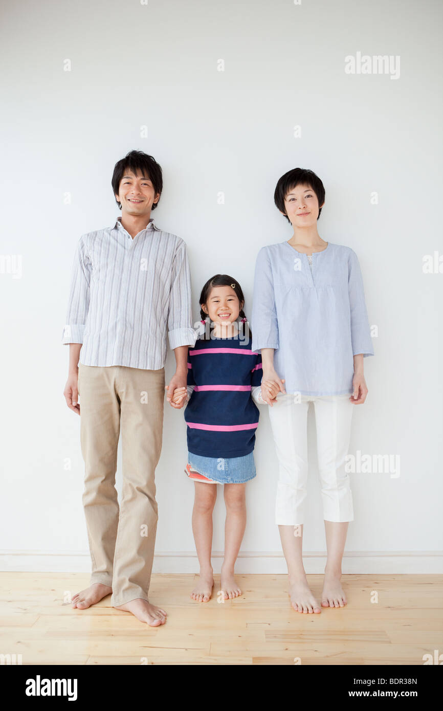Parents and daughter standing Stock Photo - Alamy