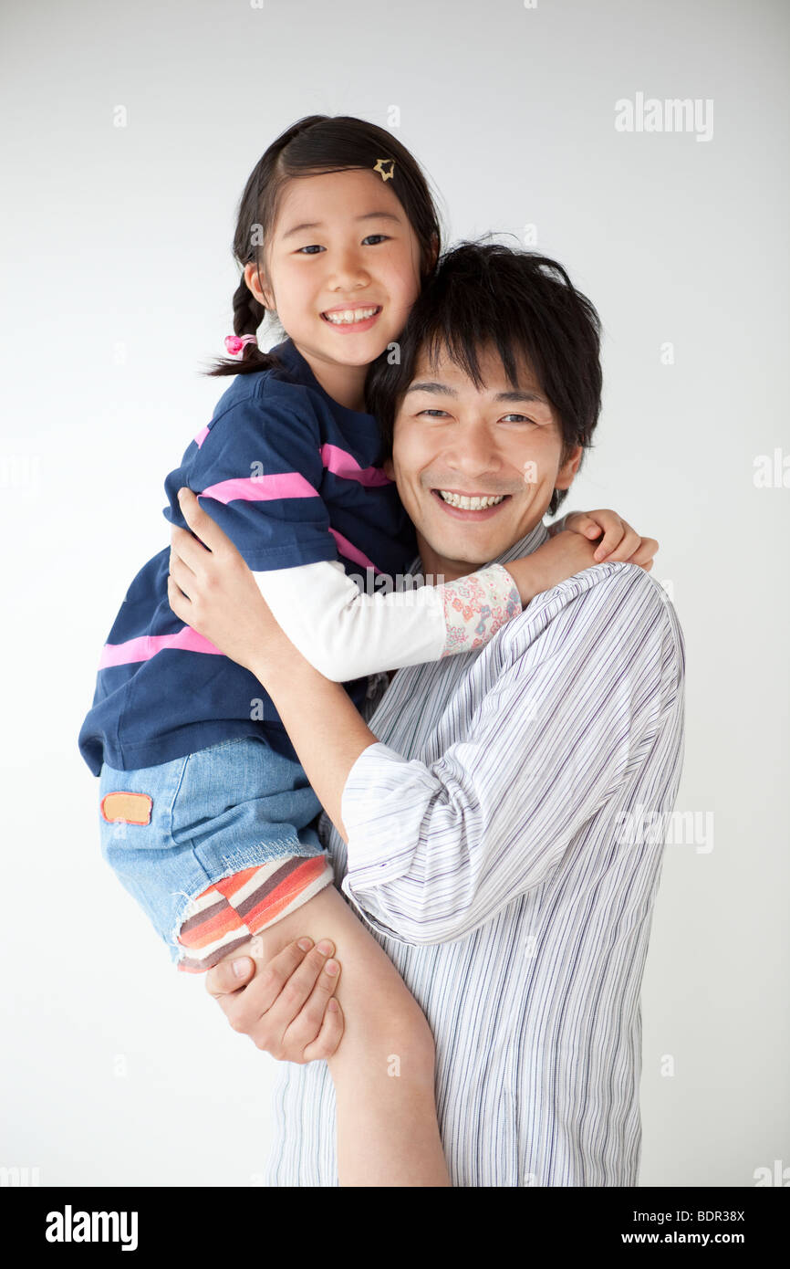 Father holding daughter Stock Photo - Alamy