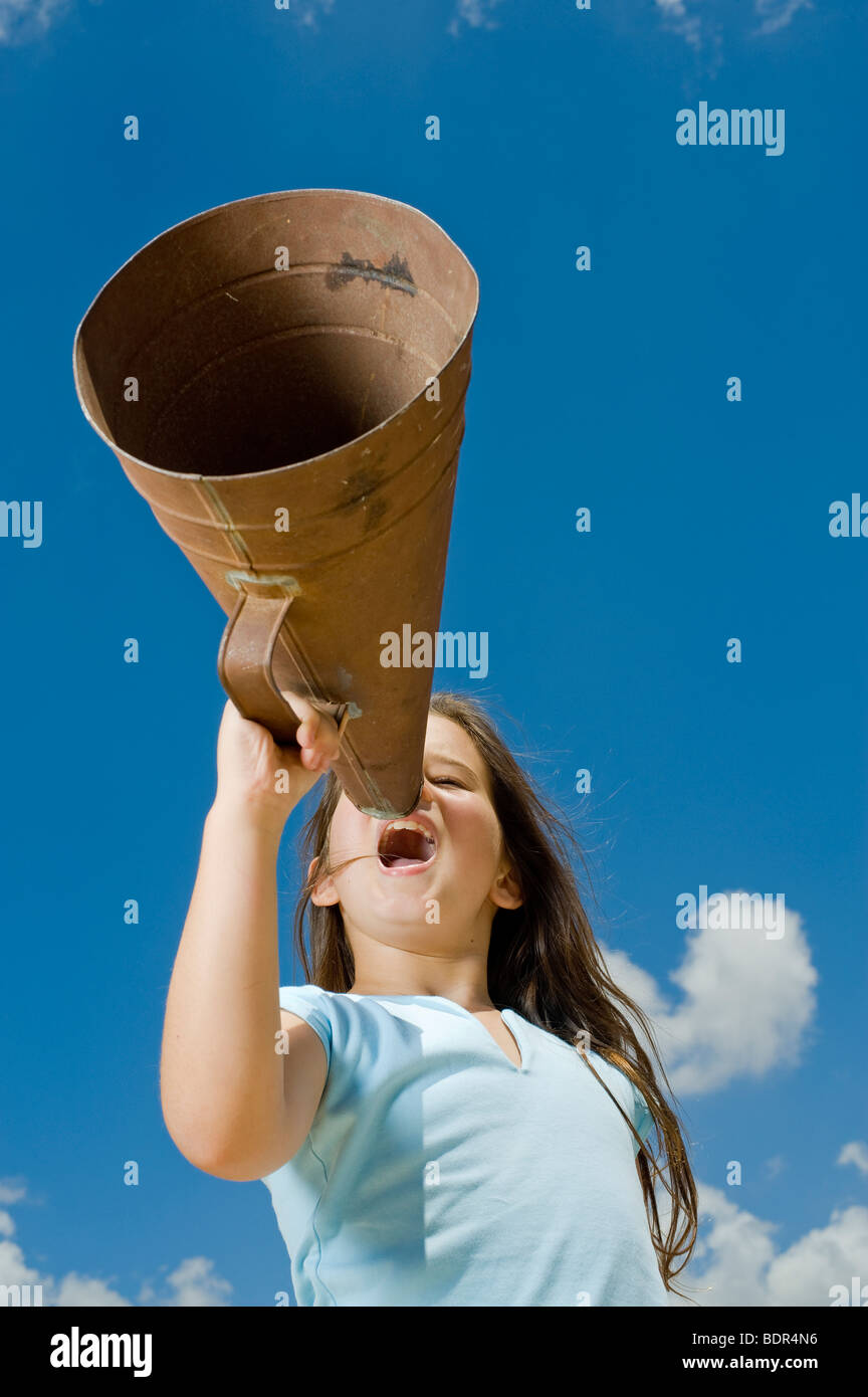 girl shouting with a megaphone against blue sky Stock Photo - Alamy