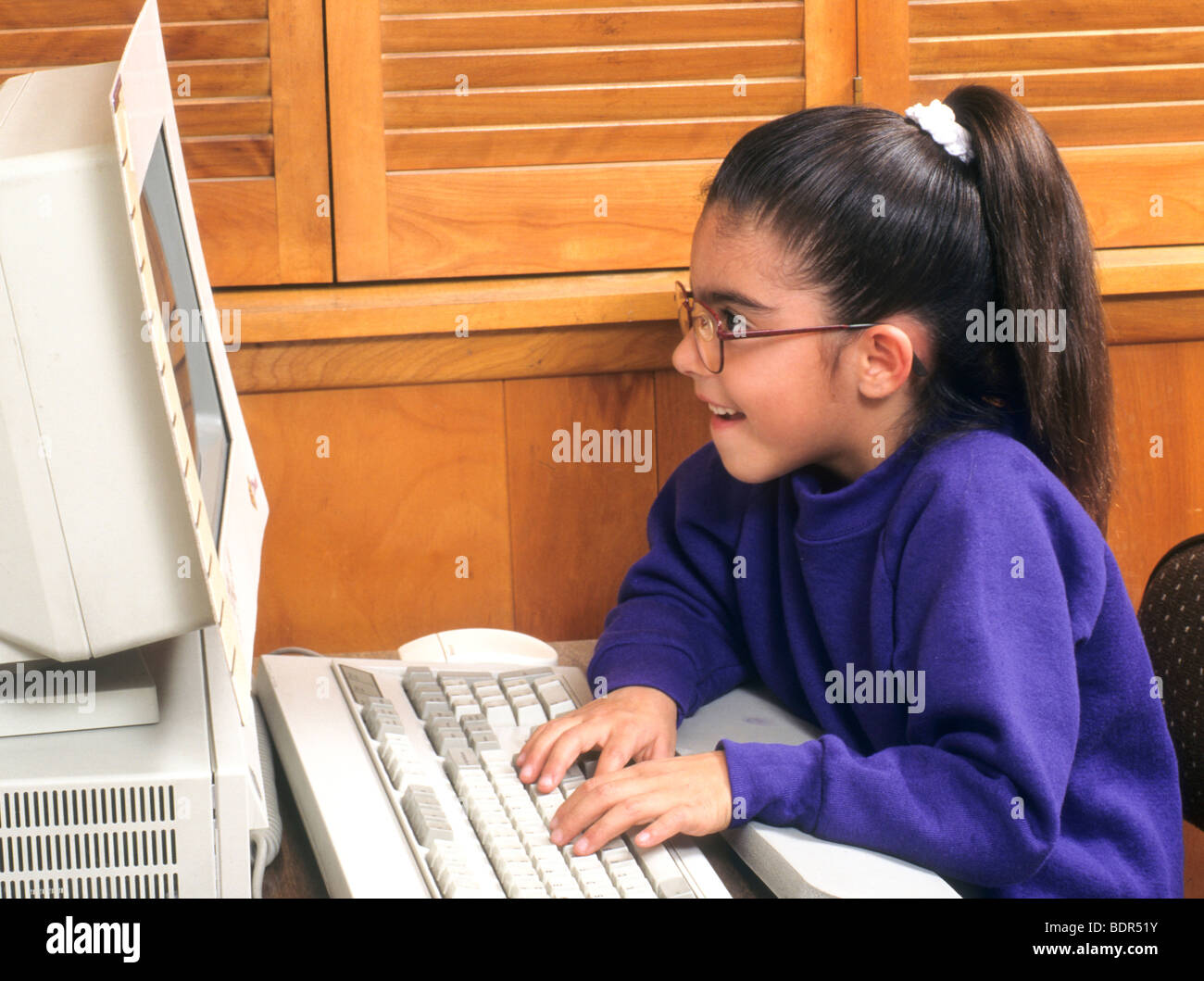 Latina female child keyboard pc glass smile fun eager learn Stock Photo ...