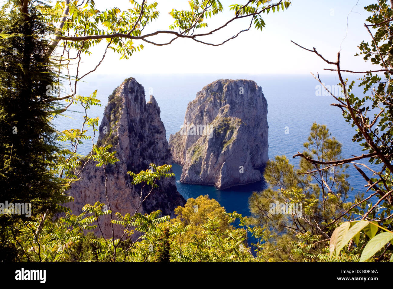 The famous Faraglioni twin Rocks surrounded by water and taken from a ...