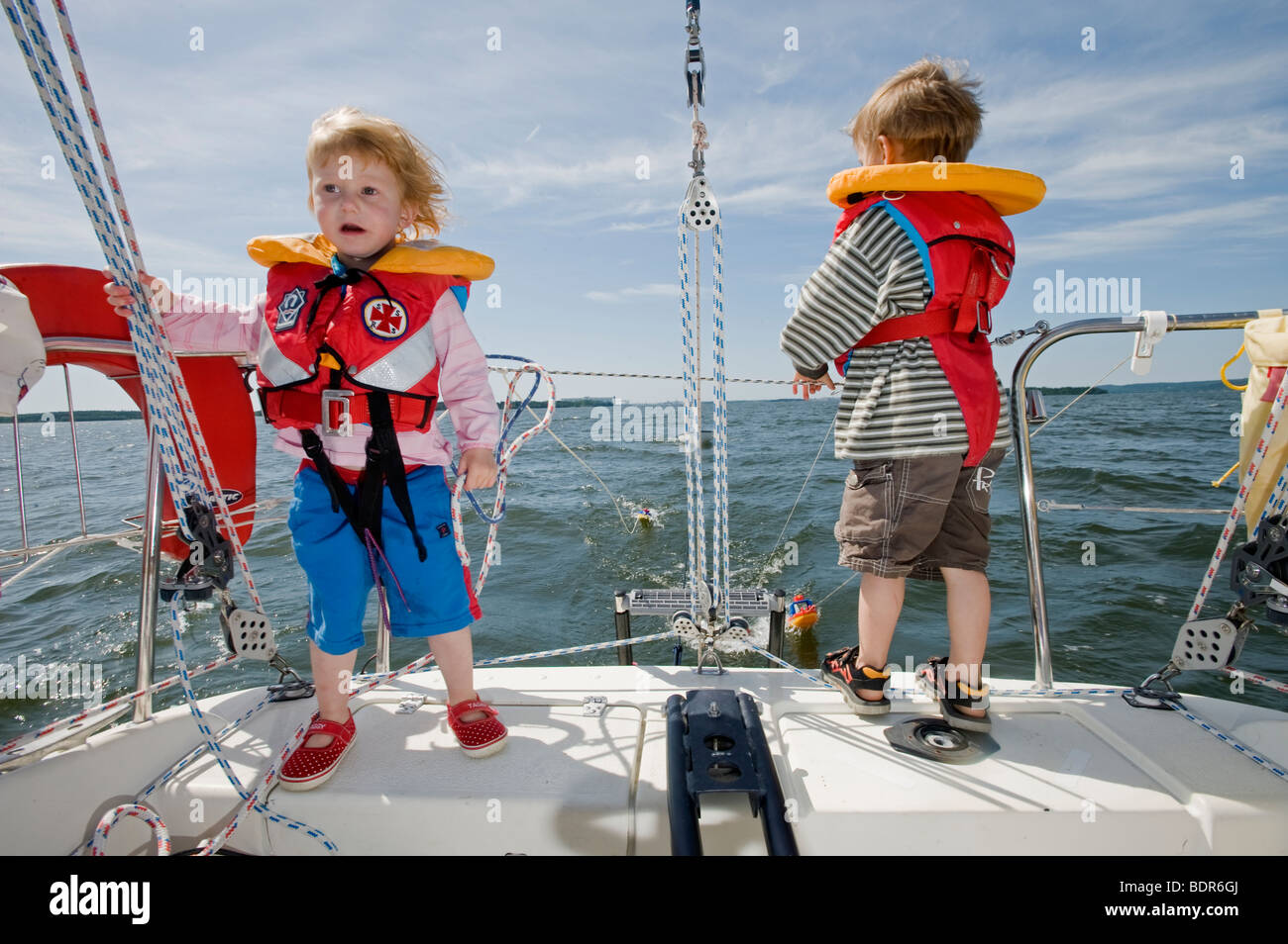 A girl and a boy standing on a sailing-boat Sweden Stock Photo - Alamy