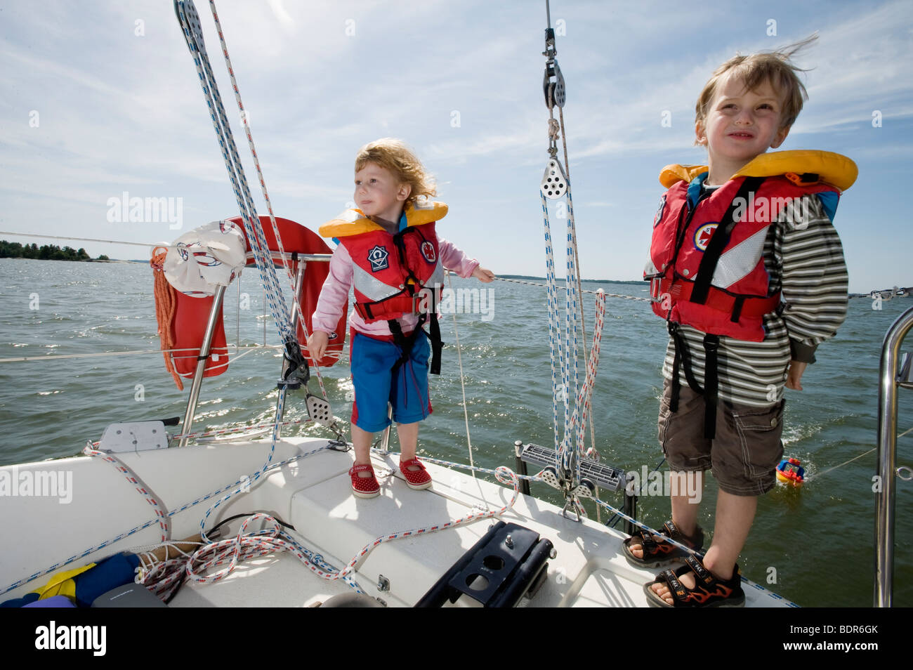 A girl and a boy standing on a sailing-boat Sweden Stock Photo - Alamy
