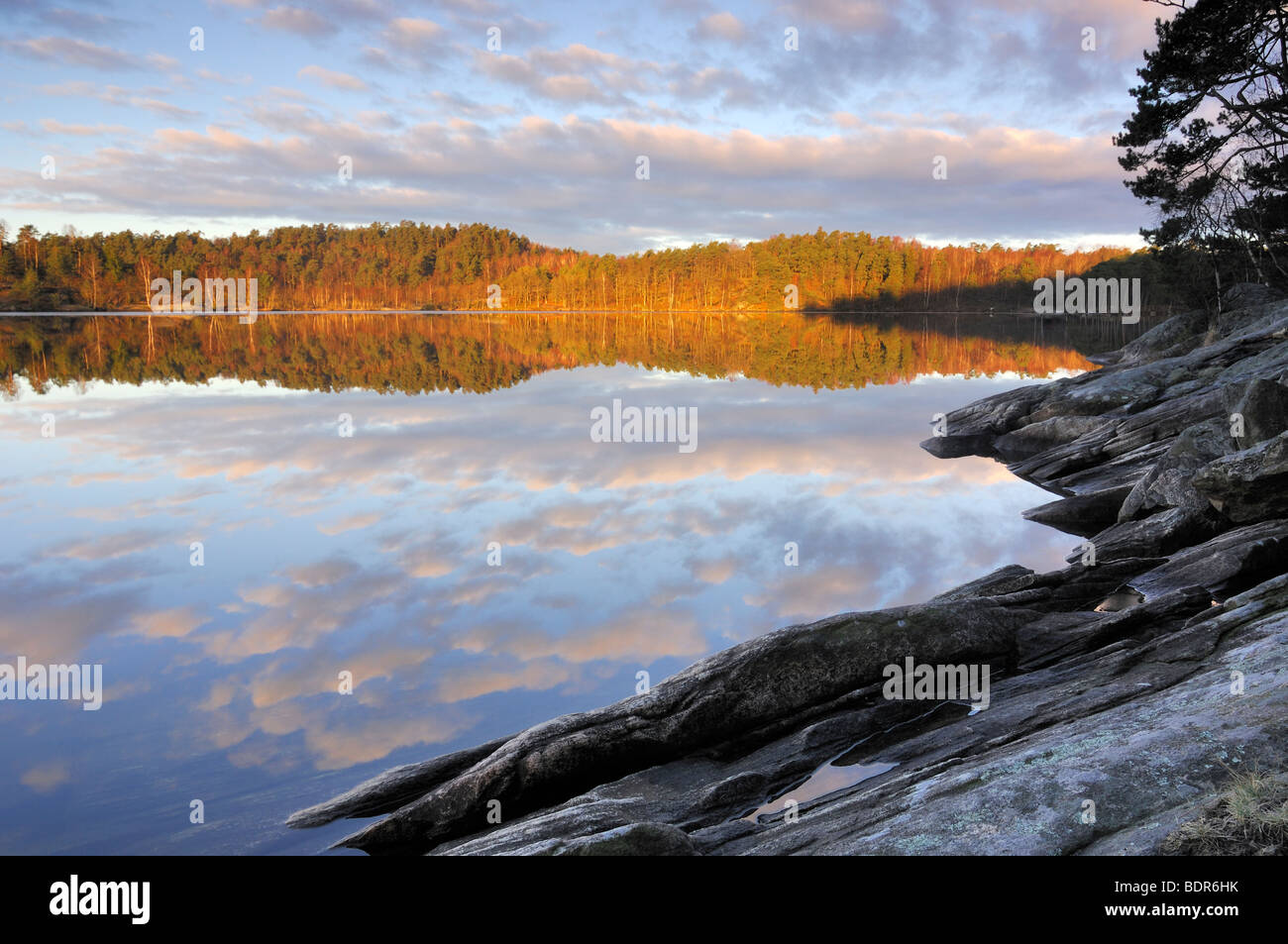 Cliffs by a lake Stock Photo - Alamy