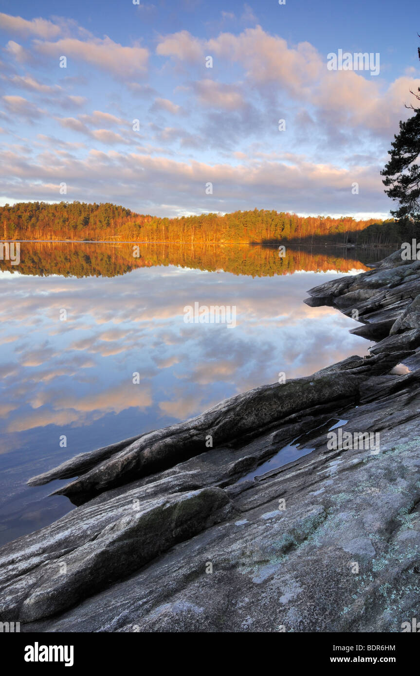 Cliffs by a lake Stock Photo - Alamy