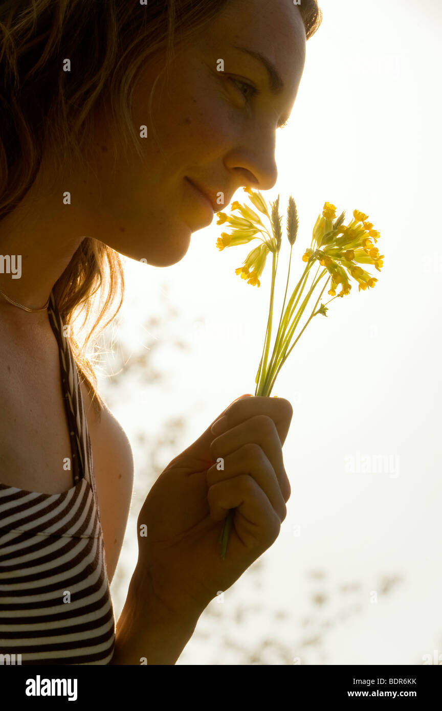 Portrait of s woman smelling a flower Stock Photo - Alamy