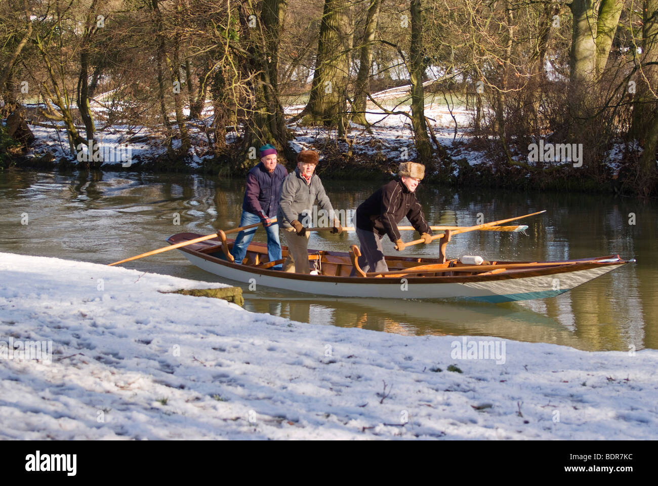 People in a rowing boat on the river Thames through Christ Church ...