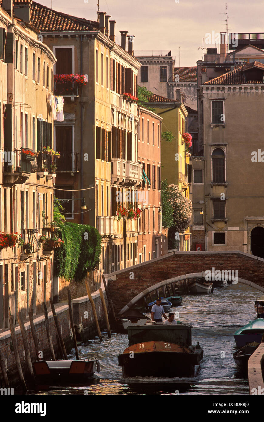Men on a boat on Canal in Venice, Italy Stock Photo - Alamy
