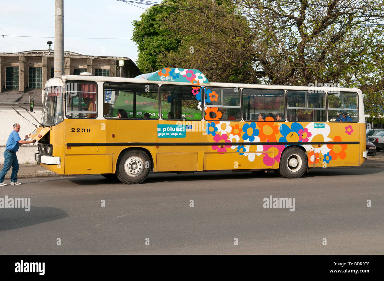 A broken down yellow bus on the E81 road between Poiana and Potlogi ...