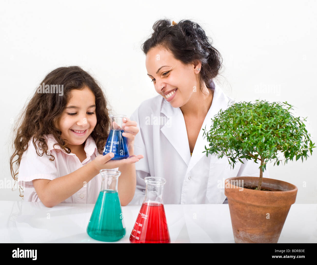 teacher girl pupil science class small tree over white Stock Photo - Alamy