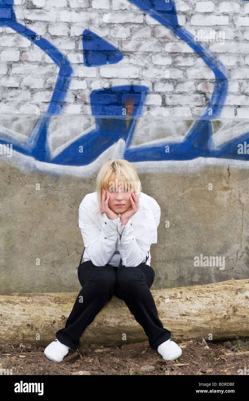 young sad woman in front of a graffiti Stock Photo - Alamy