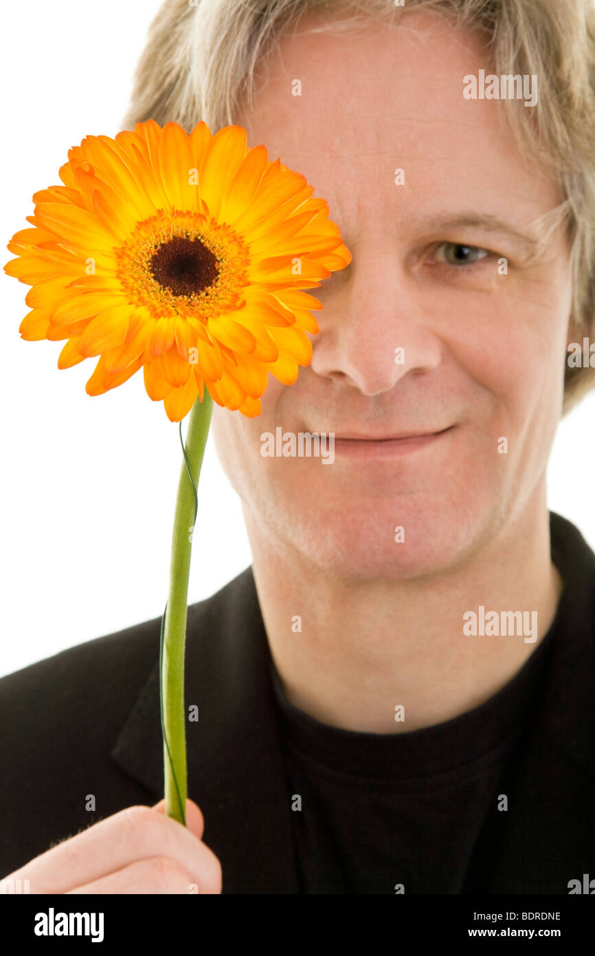 Laughing man with gerbera flower Stock Photo - Alamy