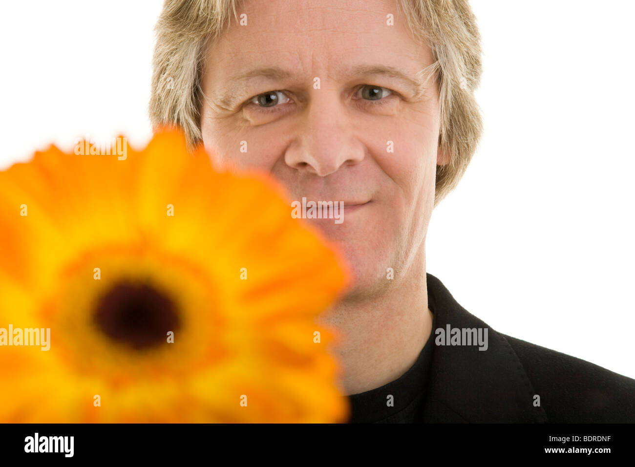 Laughing man with gerbera flower Stock Photo - Alamy