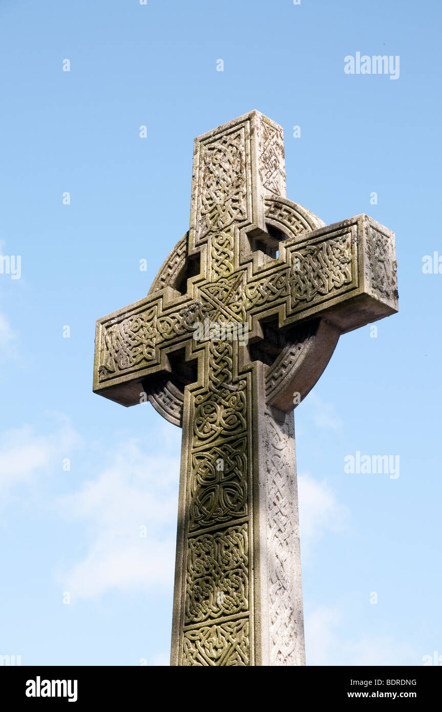 A celtic cross in dappled sunlight against a blue sky. Pictured in ...