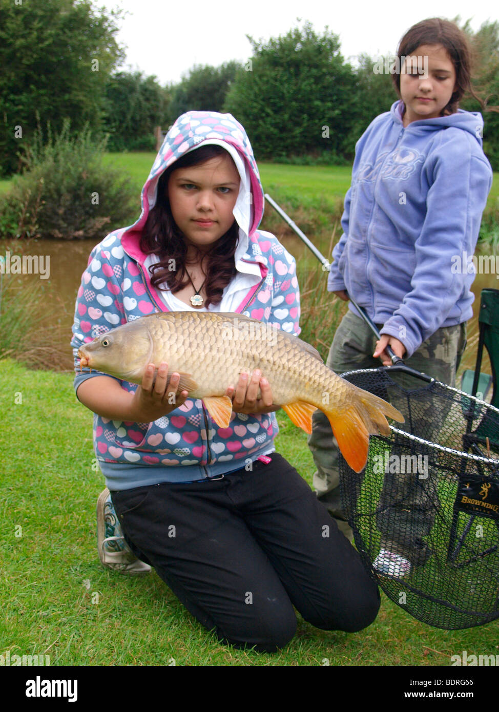 Young girls with large Carp they caught Stock Photo - Alamy