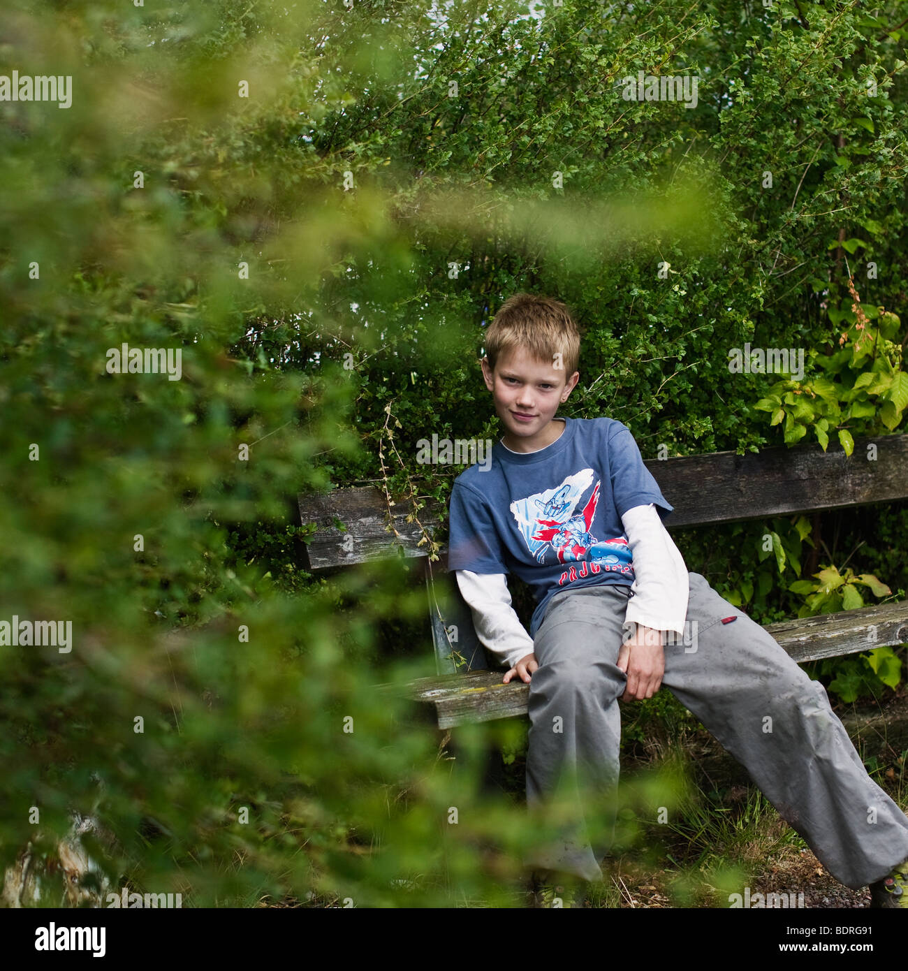 Boy Sat On Bench High Resolution Stock Photography and Images - Alamy