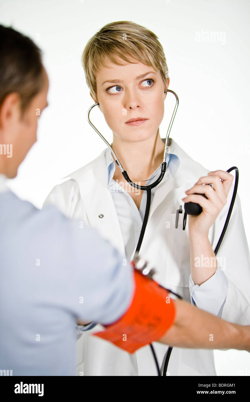 A female doctor using a blood-pressure gauge Stock Photo - Alamy