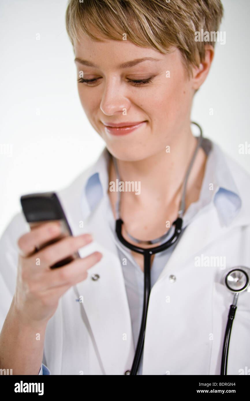 A female doctor using a mobile phone Stock Photo - Alamy